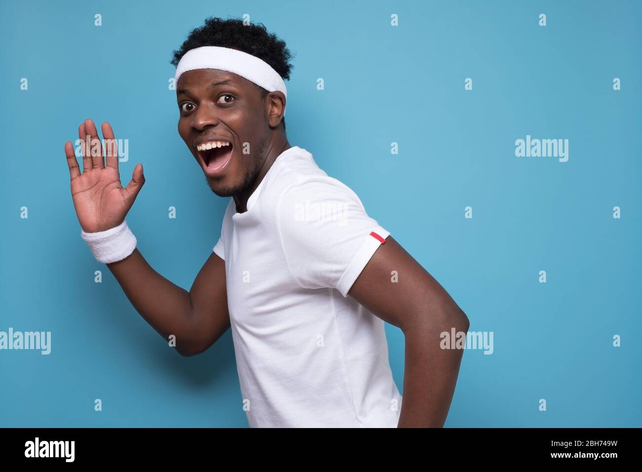 african american young man running away and looking at camera and ... african american young man running away and looking at camera and ...