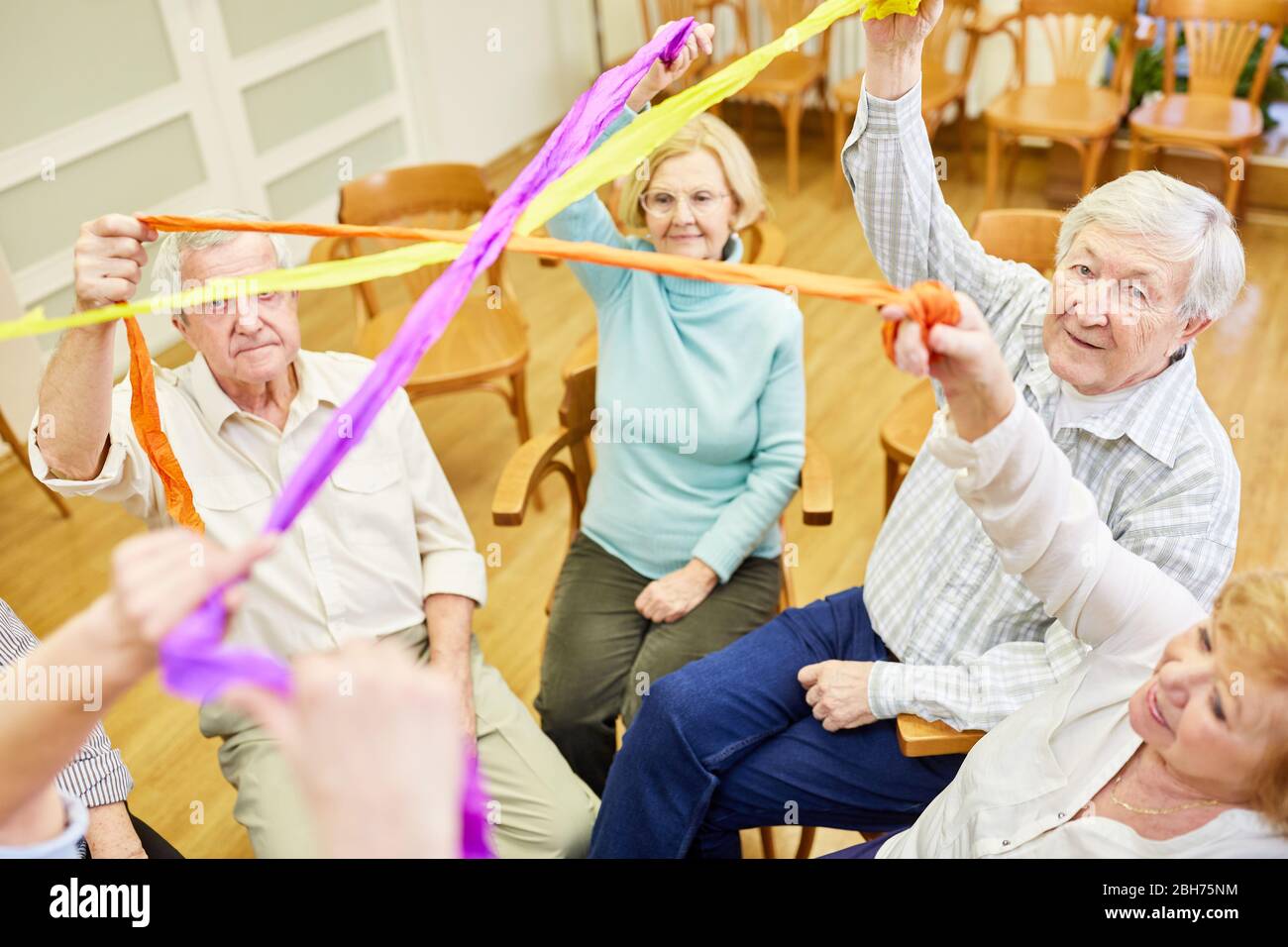 Seniors with ribbons do a community and network exercise Stock Photo ...