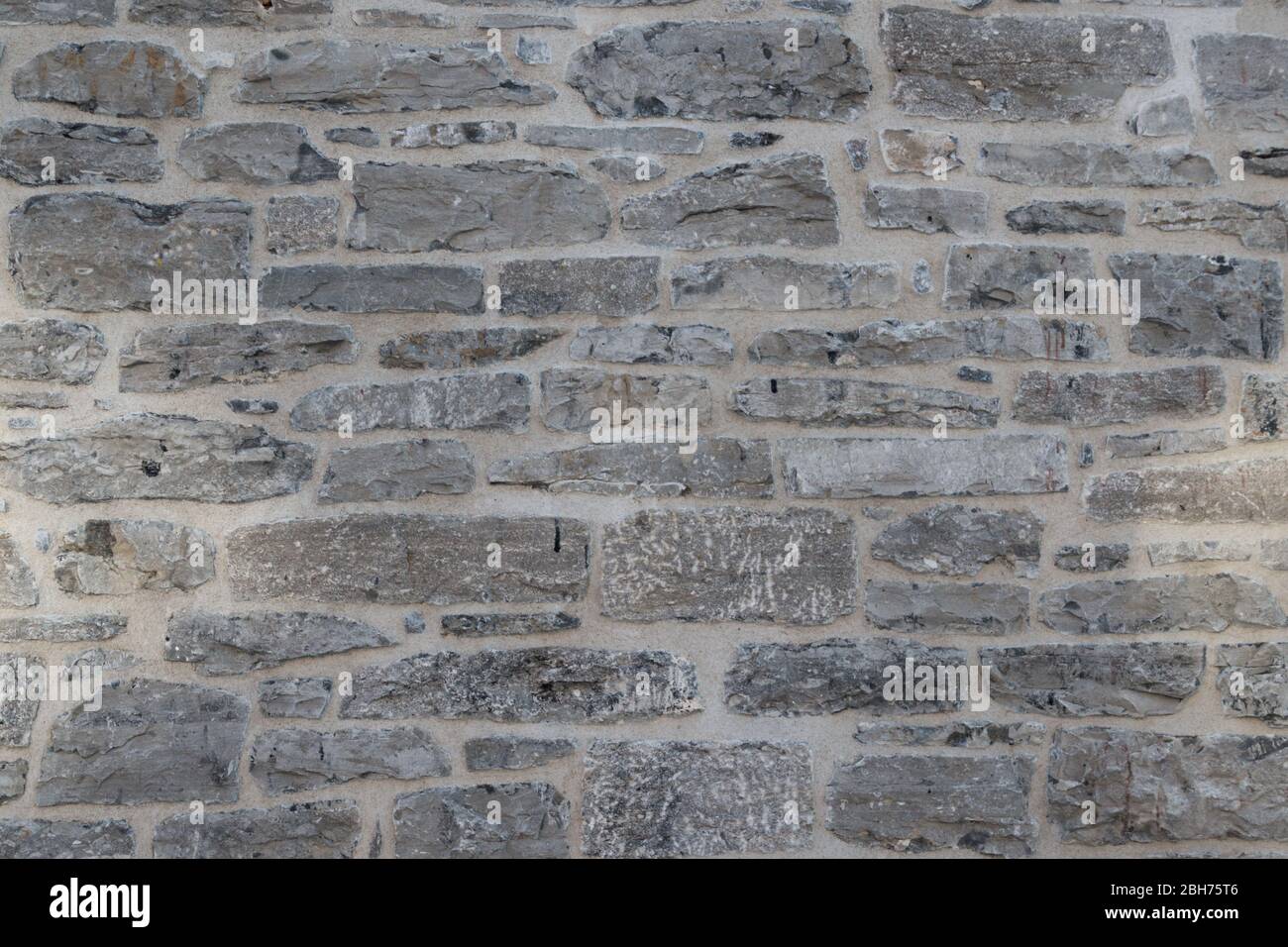 Textured natural wallpaper of hammered chiseled granite stone wall and ...