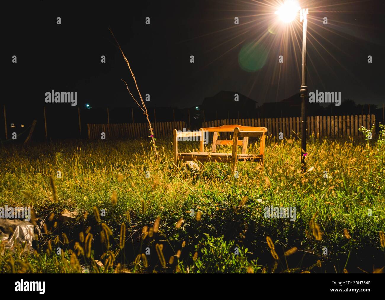 A bench under an old lantern Stock Photo - Alamy