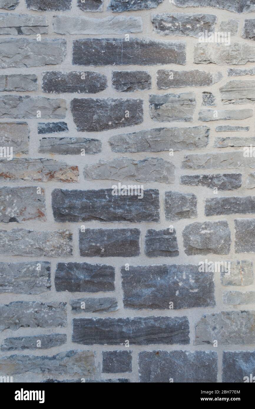 Textured natural wallpaper of hammered chiseled granite stone wall and ...