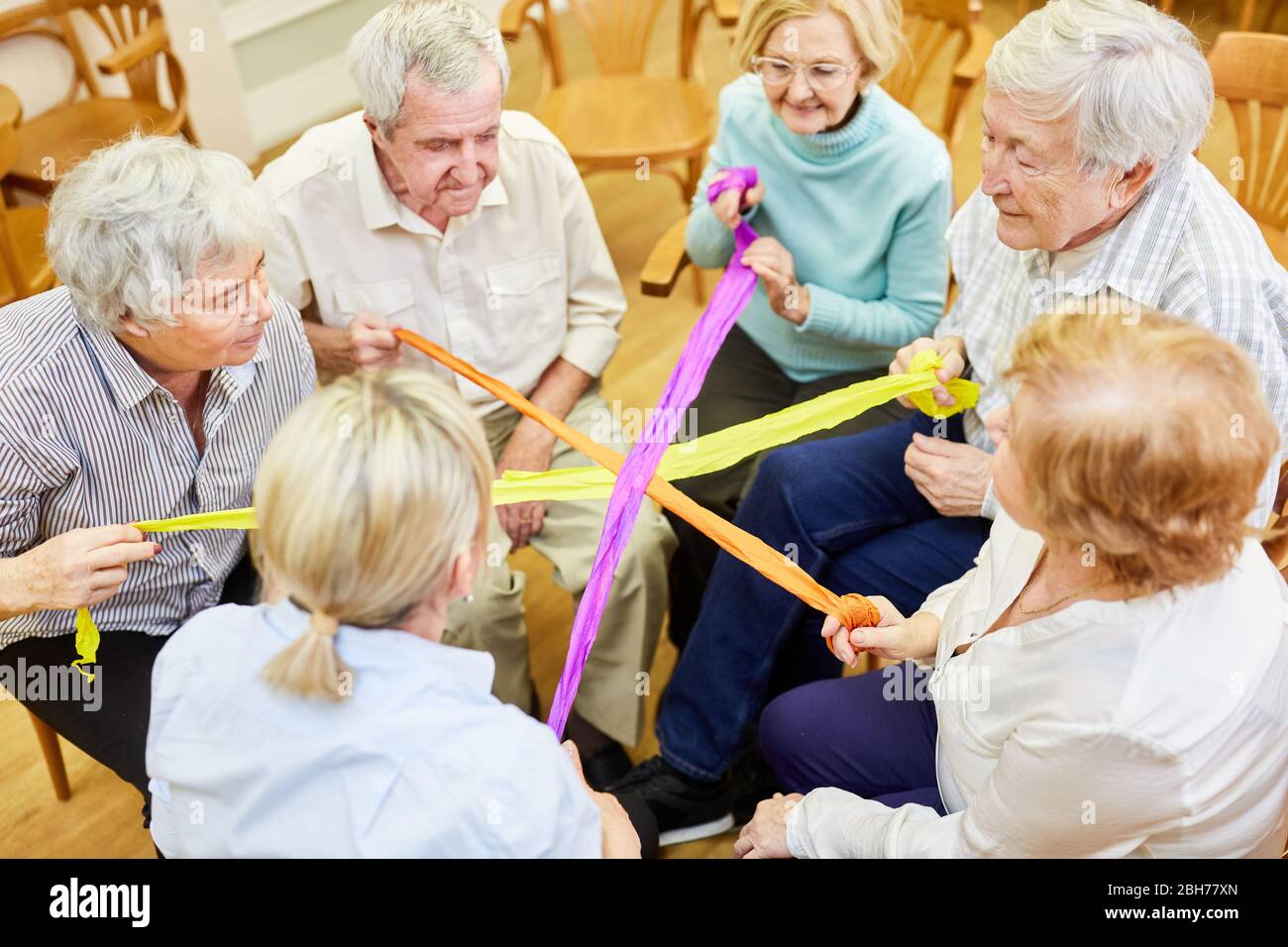 Group of discreet seniors with colorful ribbons in a group therapy ...