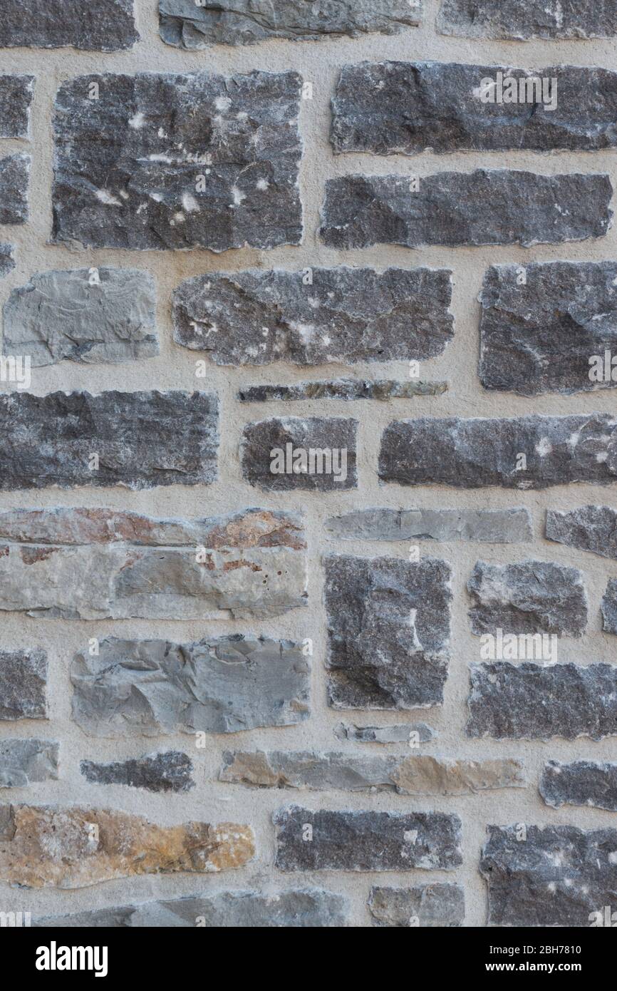 Textured natural wallpaper of hammered chiseled granite stone wall and ...