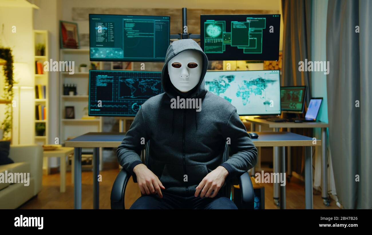 Cyber criminal wearing a white mask using augmented reality to steal ...