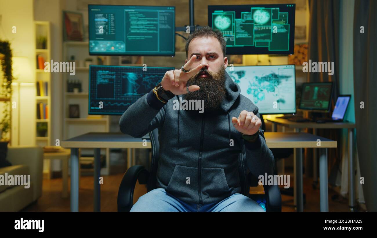 Bearded hacker doing hand gestures using augmented reality while ...
