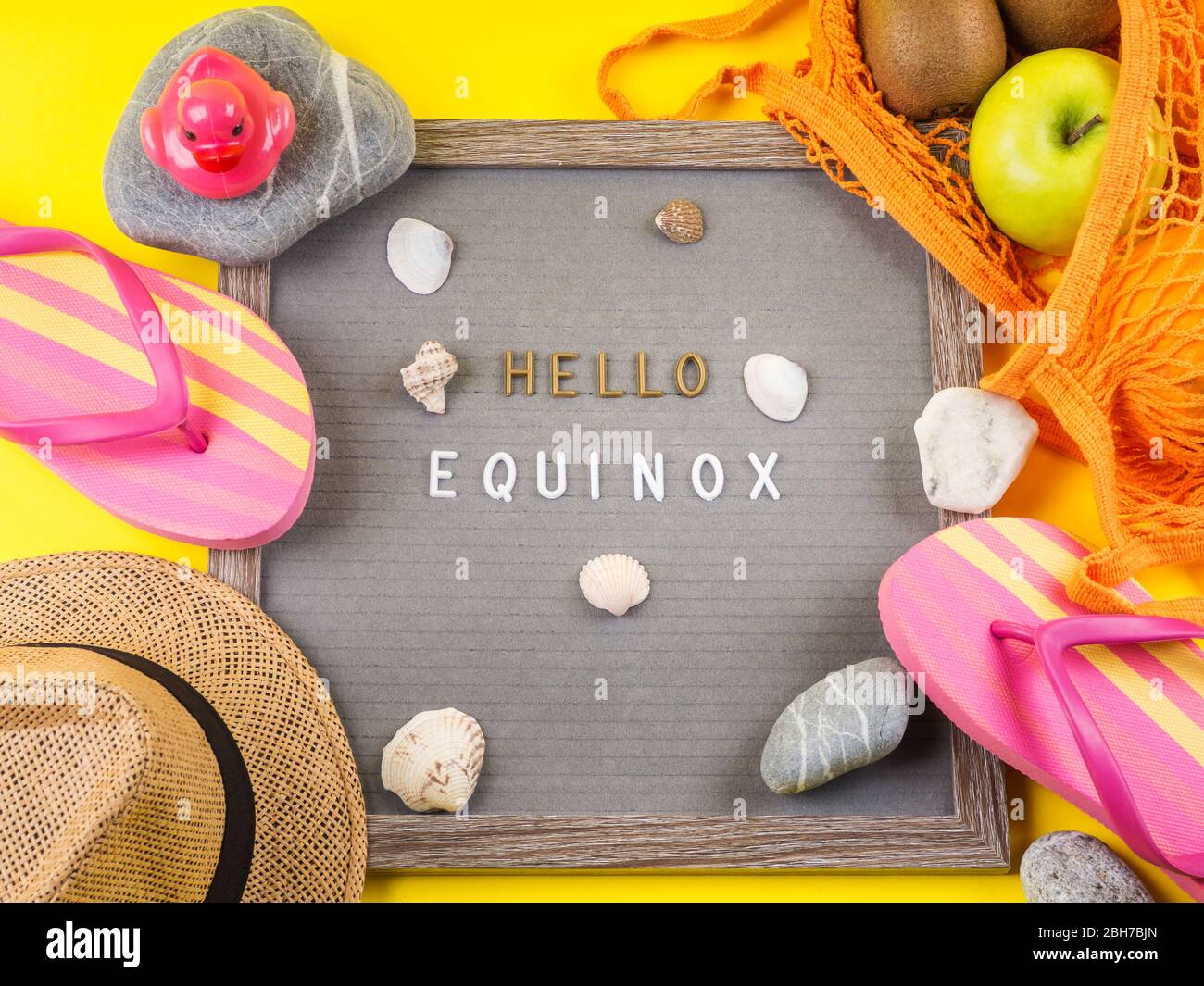 Hello equinox text on letter board with seashells Stock Photo - Alamy