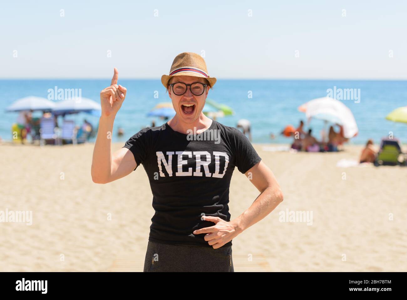 Happy young nerd tourist man having idea at the beach Stock Photo - Alamy