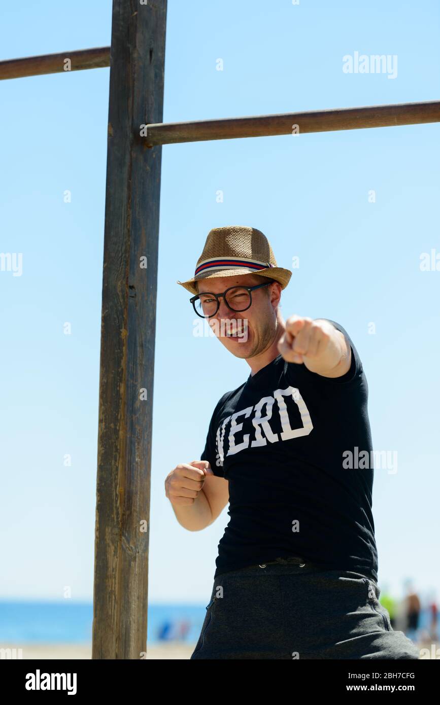 Smiling young guy pointing at camera Stock Photo - Alamy