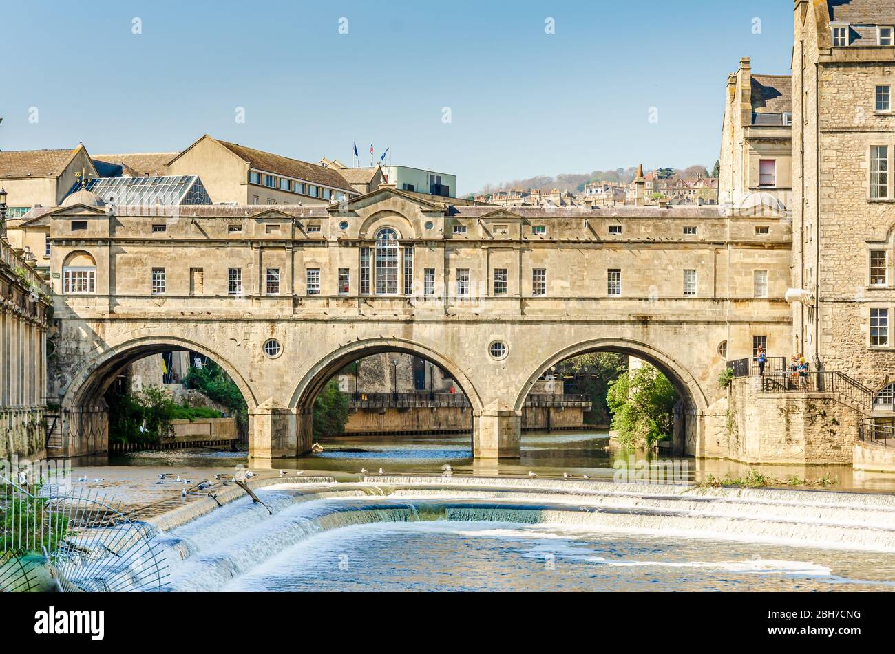 Pulteney Bridge over the River Avon with the weir in the city of Bath ...