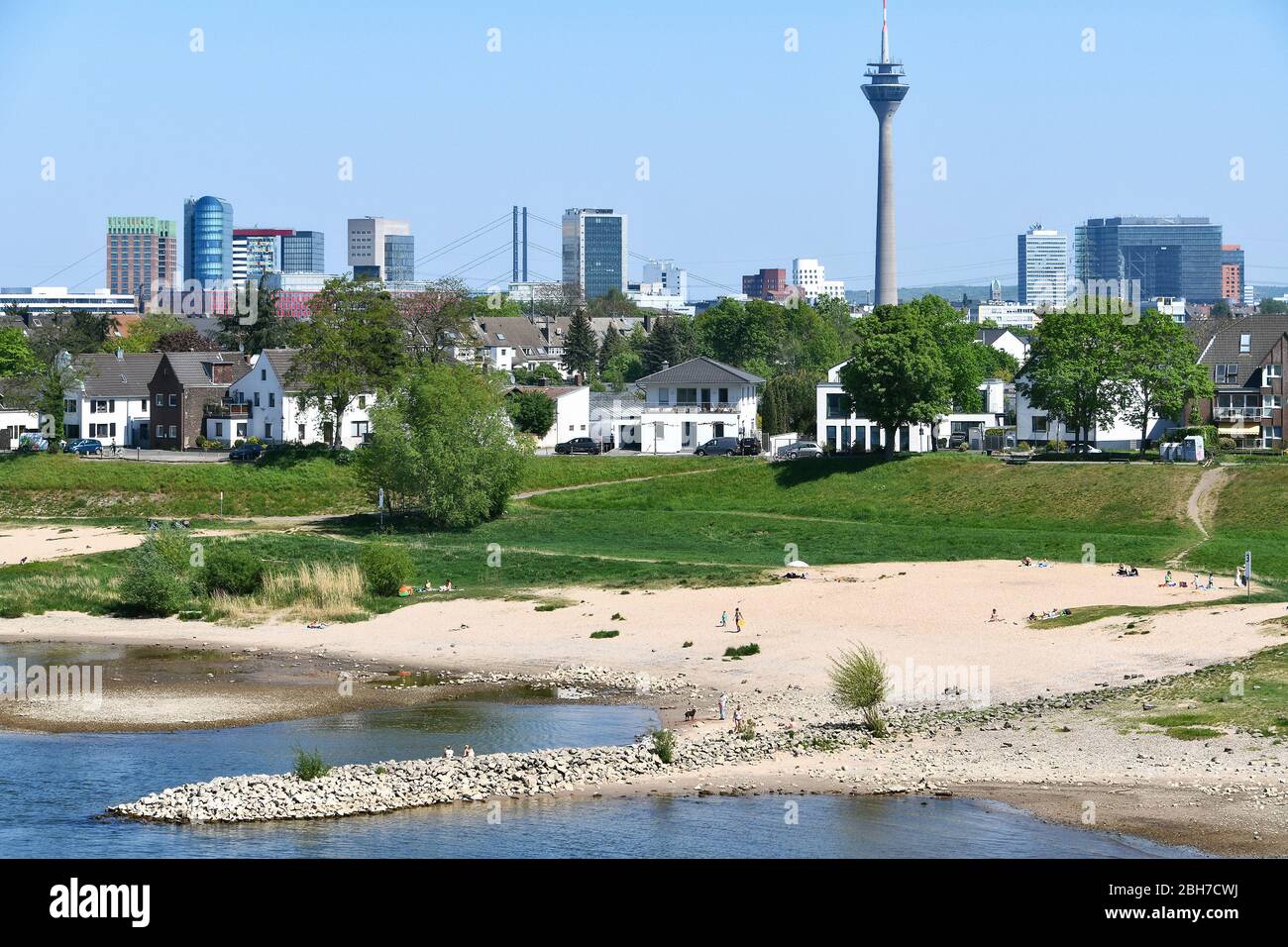 Sandy beaches on the Rhine near Dusseldorf. In the background the ...