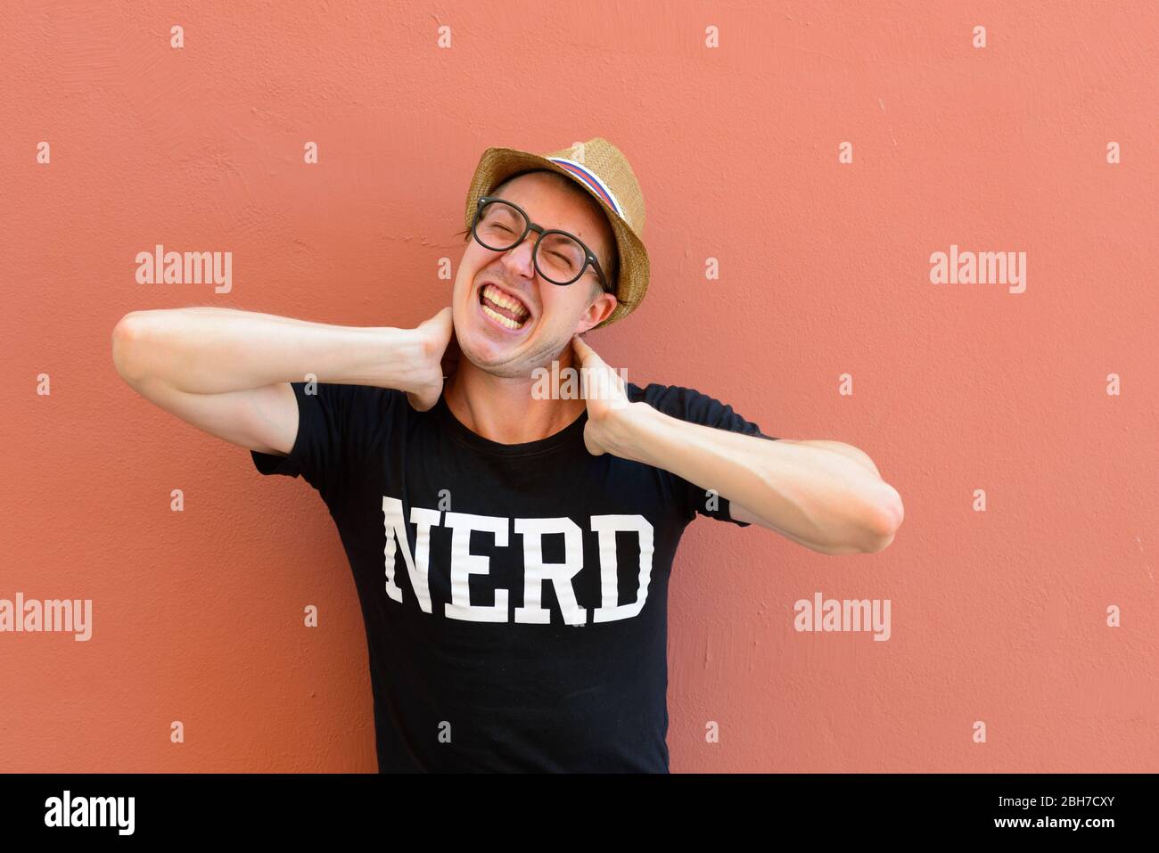 Portrait of stressed young nerd tourist man having neck pain Stock ...