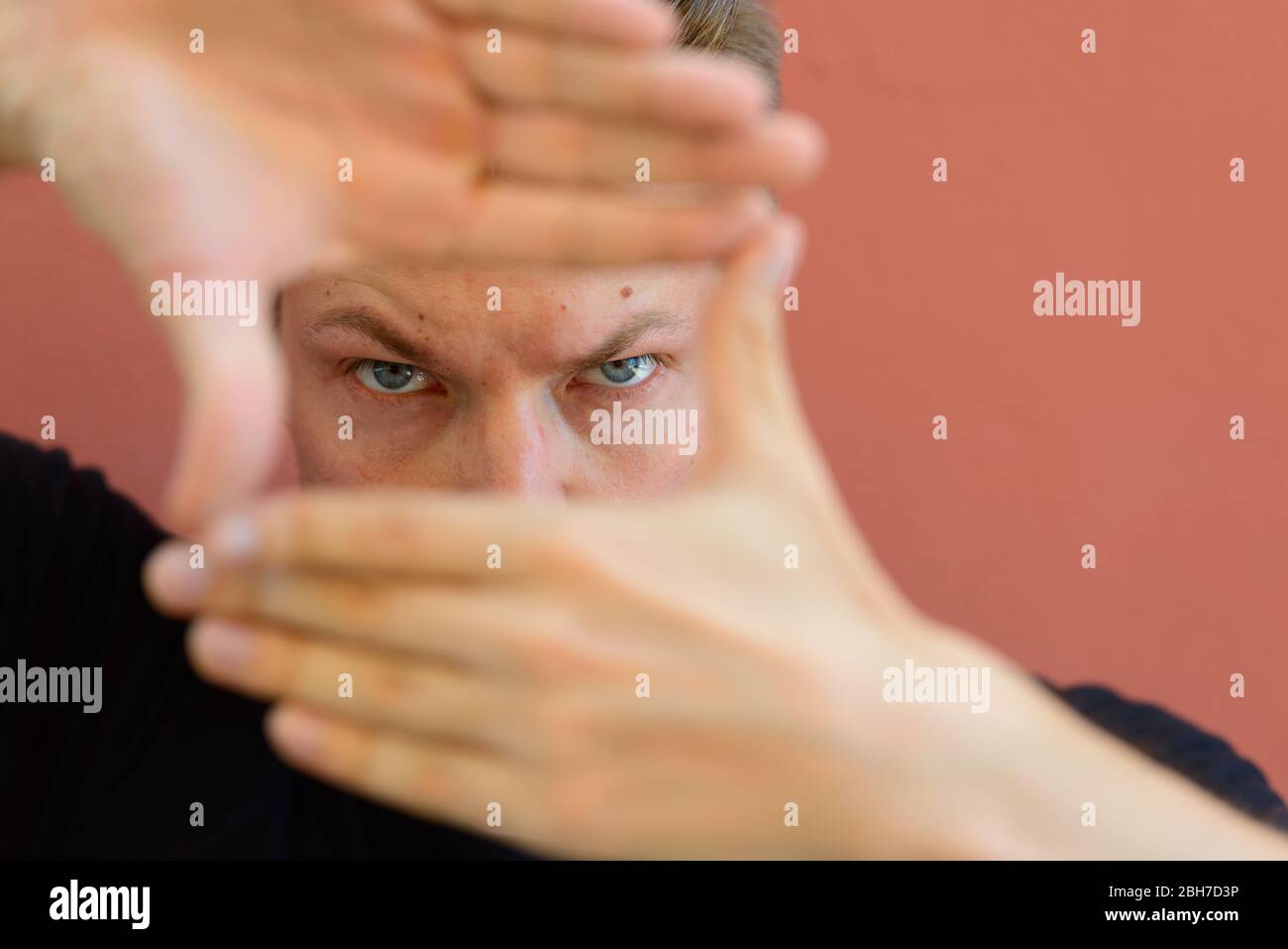 Face of young handsome man focusing with finger frame gesture Stock ...