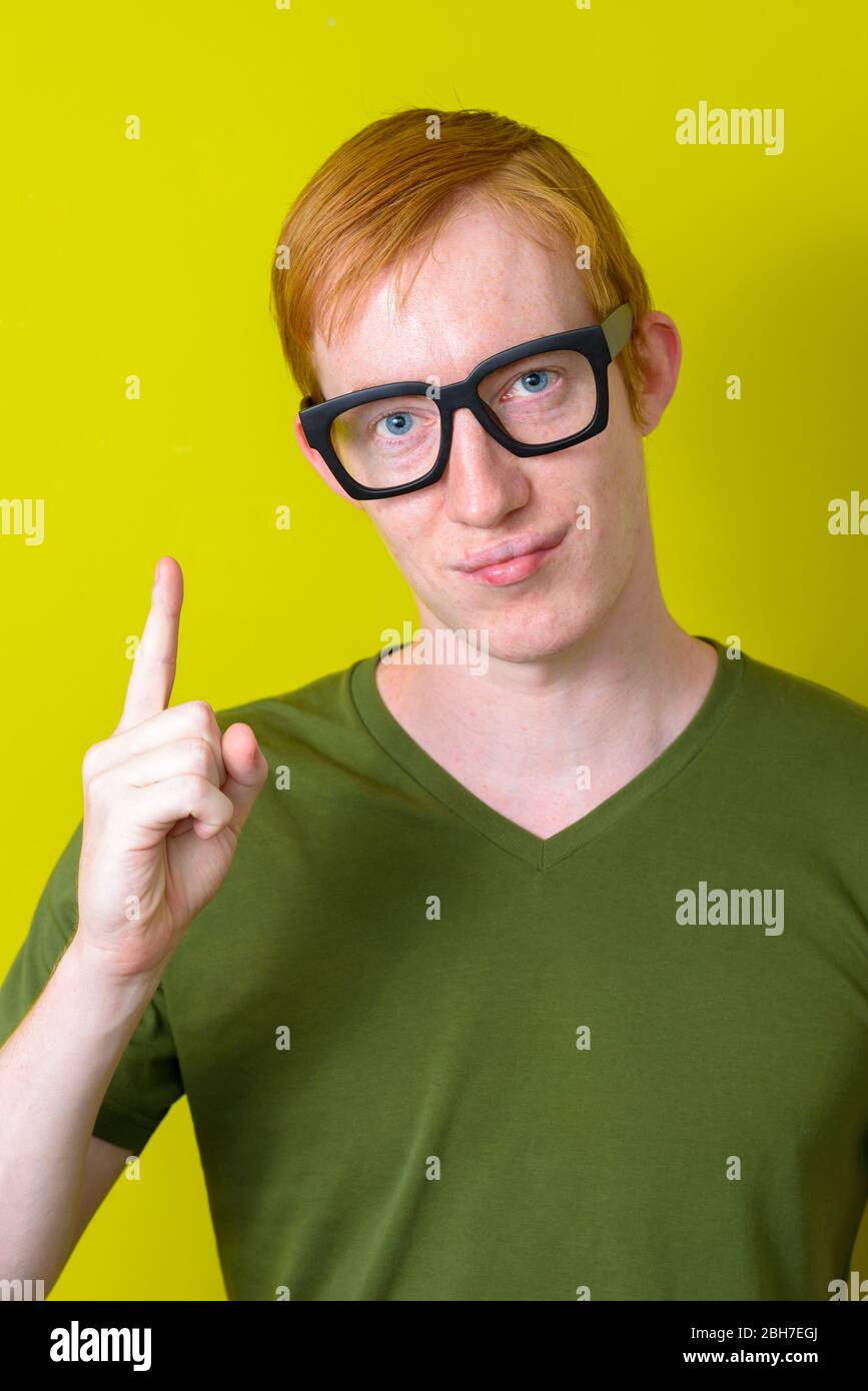 Face of nerd man with red hair wearing eyeglasses and pointing up Stock ...