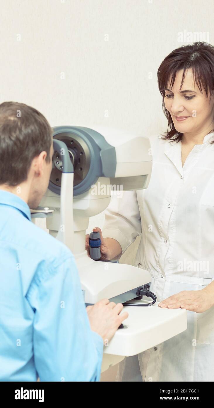 ophthalmologist doctor in exam optician laboratory with male patient ...