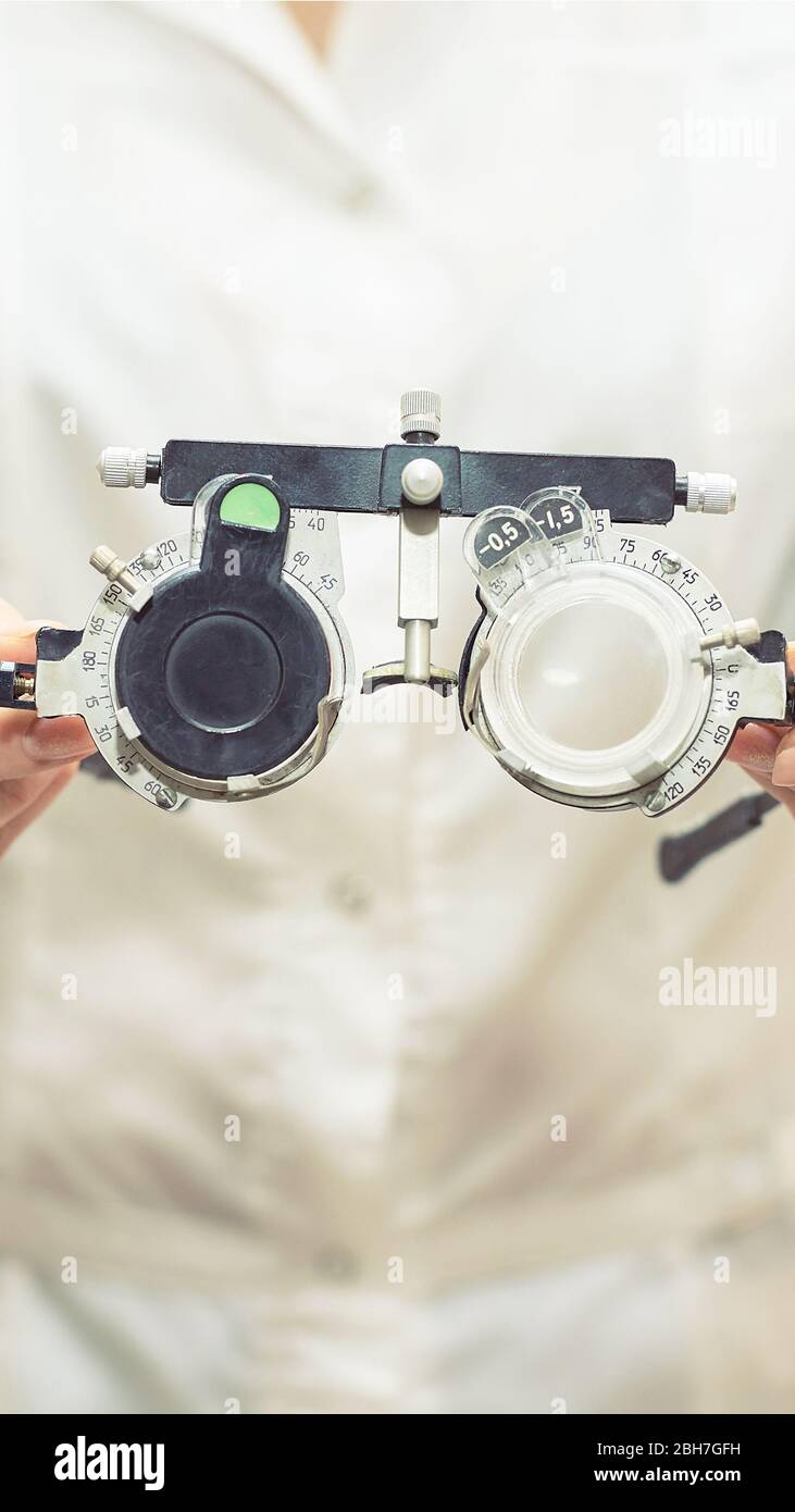 ophthalmologist doctor in exam optician laboratory with female patient ...