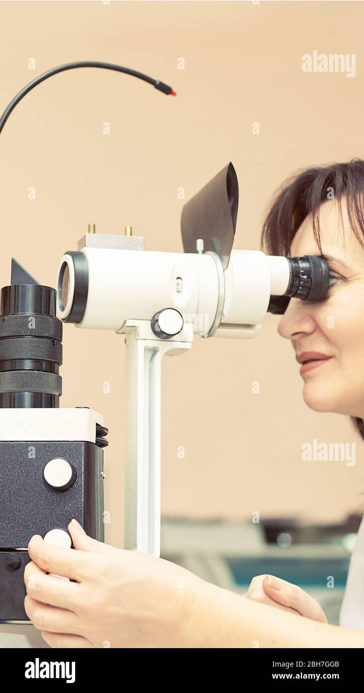 ophthalmologist doctor in exam optician laboratory with female patient ...