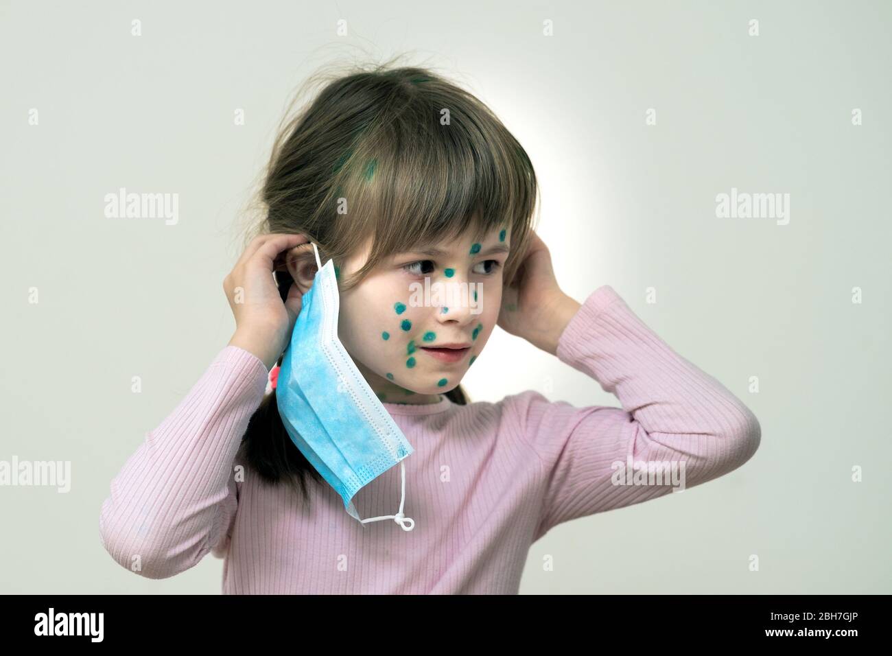Child girl wearing blue protective medical mask ill with chickenpox ...