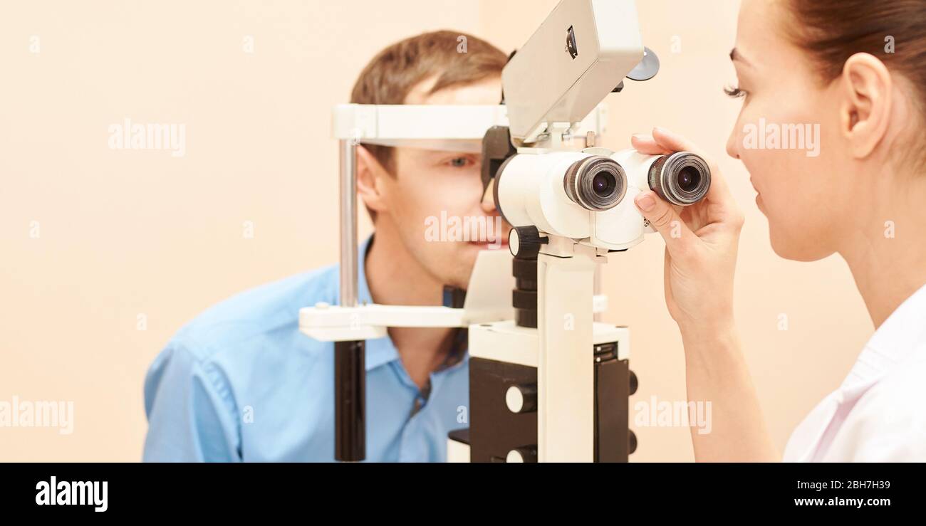 ophthalmologist doctor in exam optician laboratory with male patient ...
