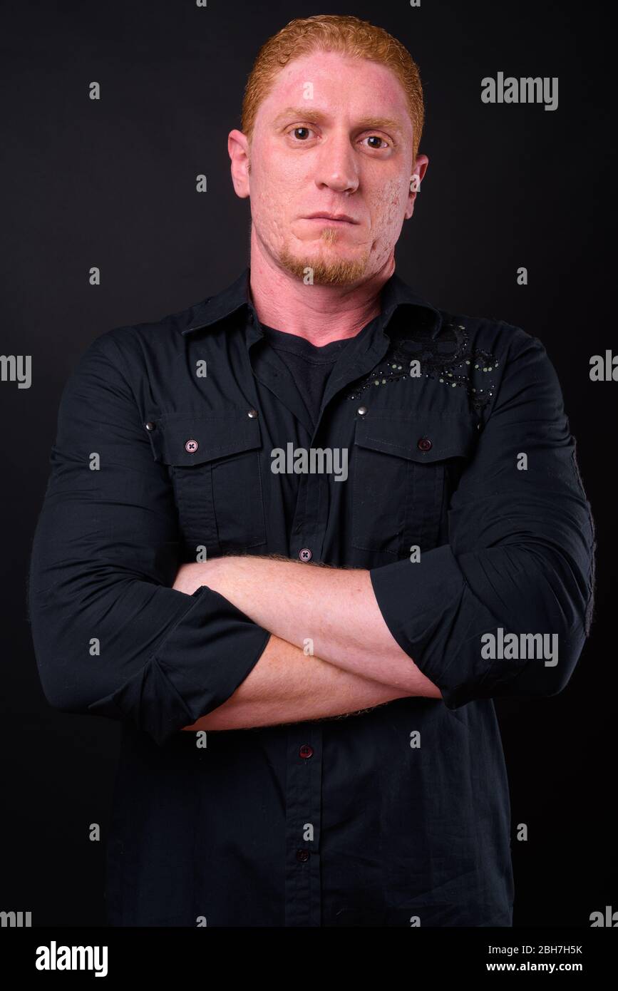 Portrait of muscular man with orange hair looking confident Stock Photo ...