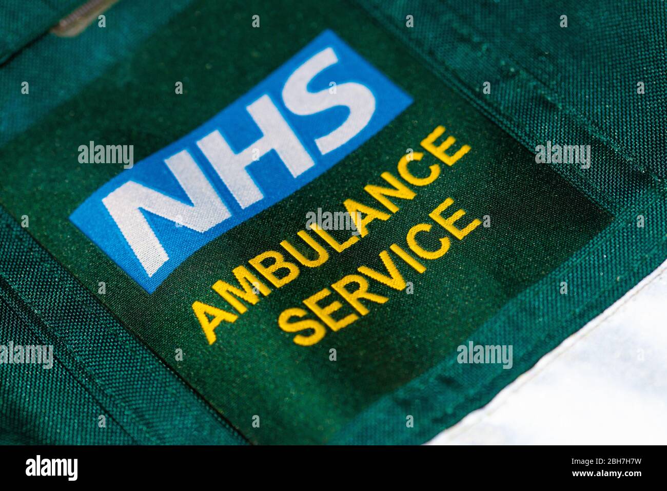 Close up, angled view of a British paramedic badge on uniform jacket ...