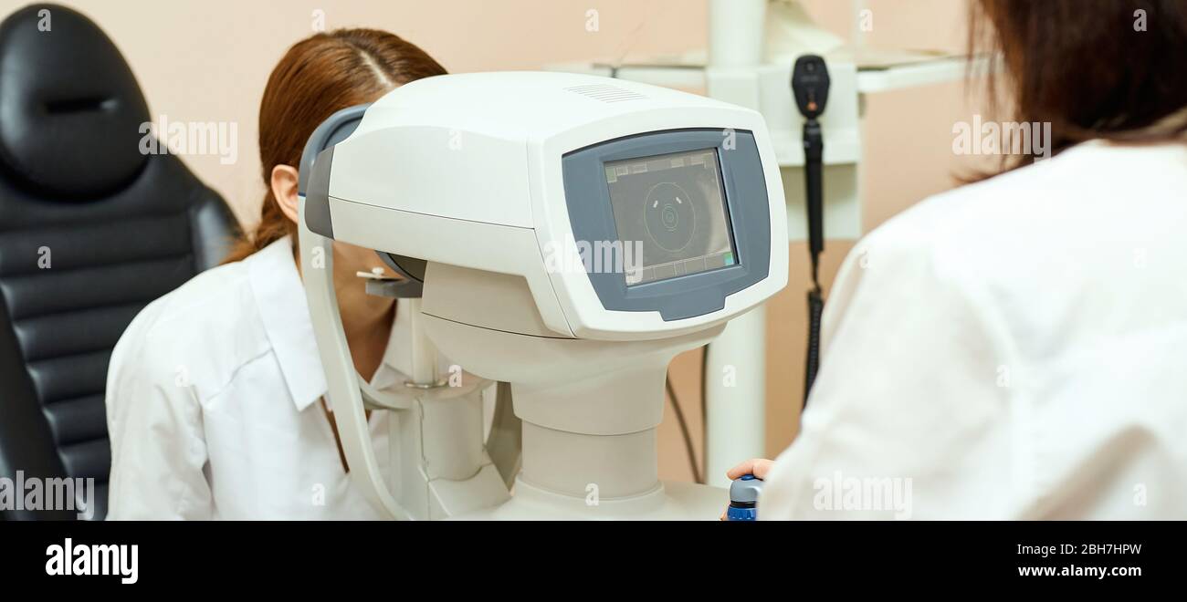 ophthalmologist doctor in exam optician laboratory with female patient ...