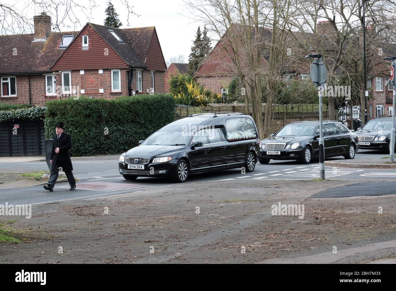 Funeral Director walking in front of hearce, Isleworth, London Stock ...