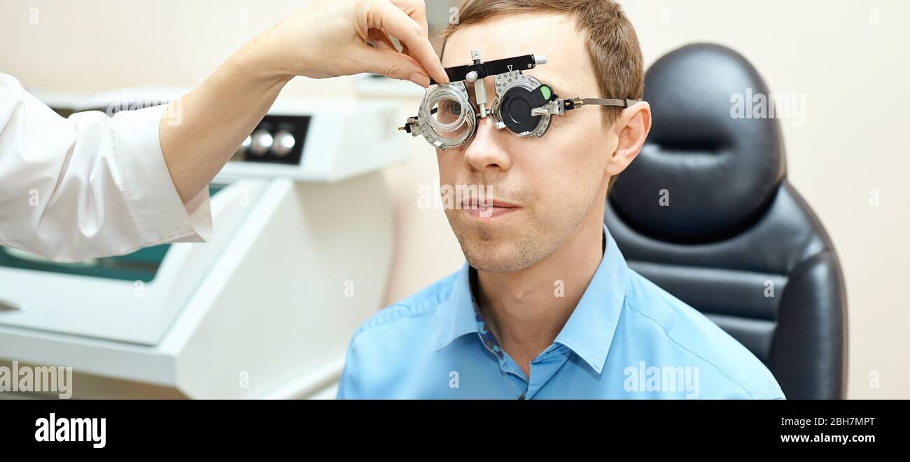 ophthalmologist doctor in exam optician laboratory with male patient ...