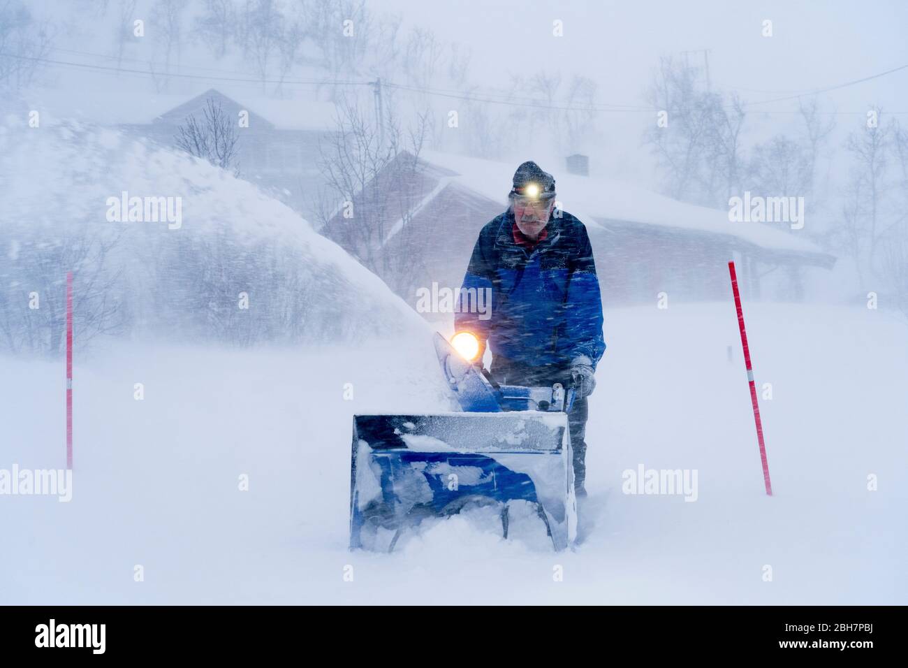 facility manager riding a snowblower in a heavy blizzard in northern ...