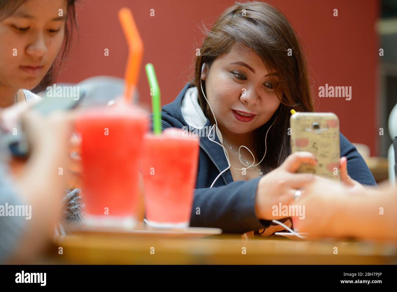 Group of young Asian women as friends hanging out together outdoors ...