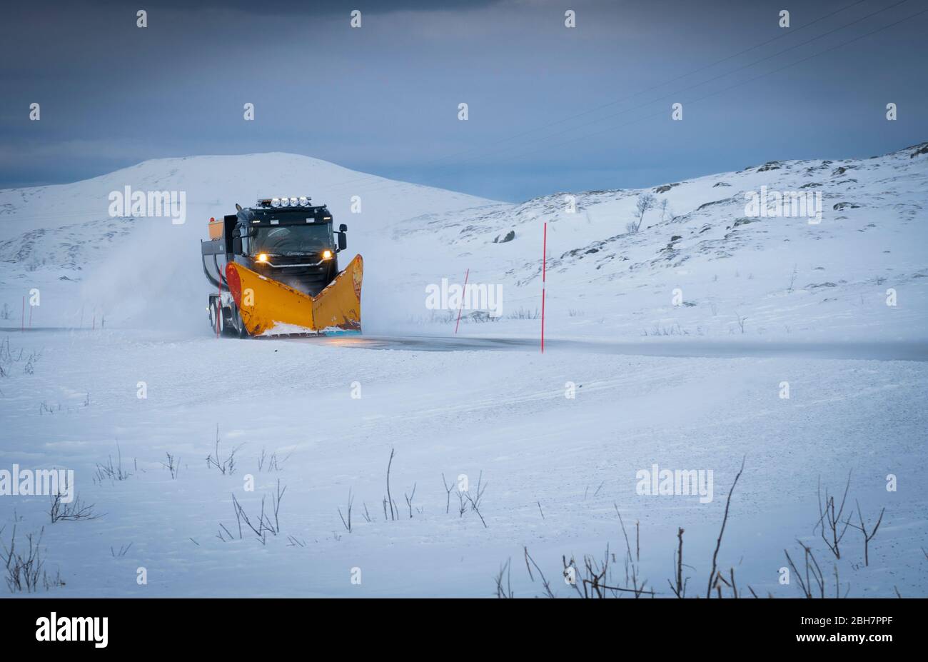 snowplow in action on a icy road in northern Norway near Tromsoe Stock ...