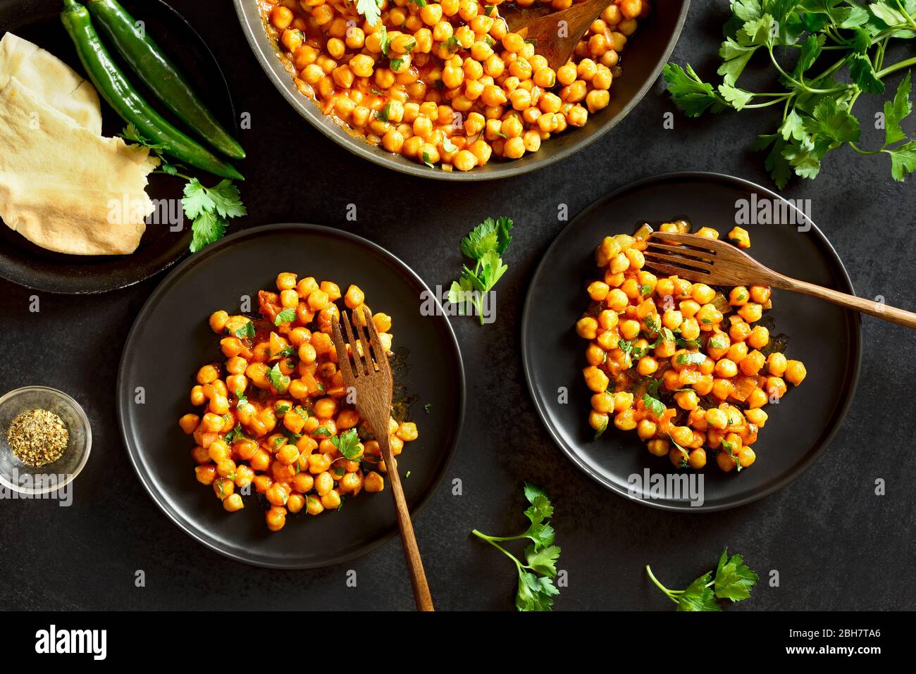 Indian style crispy roasted chickpeas over black stone background ...