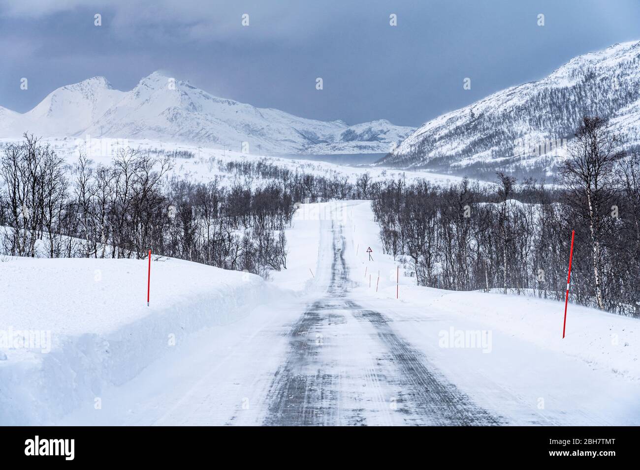 icy and snow covered road during a blizzard in the highland Tundra of ...