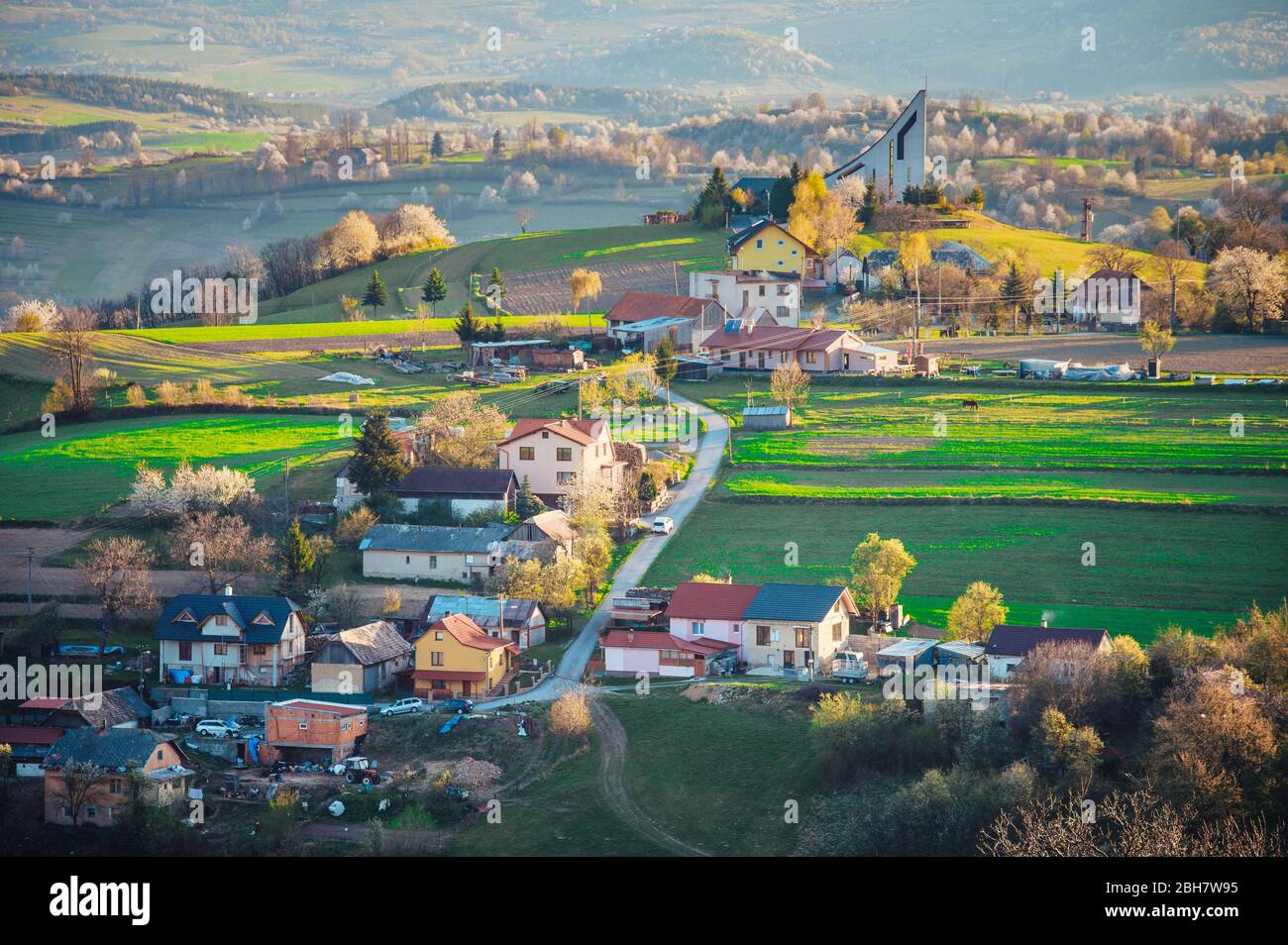 Church in spring rural landscape, colorful warm sunrise light. Religion ...