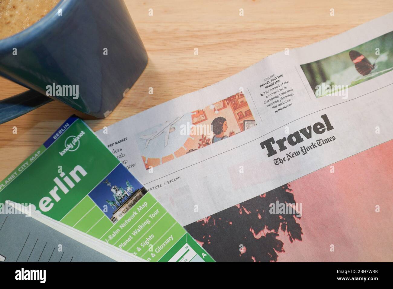 Travel section of the newspaper and a cup of coffee Stock Photo - Alamy