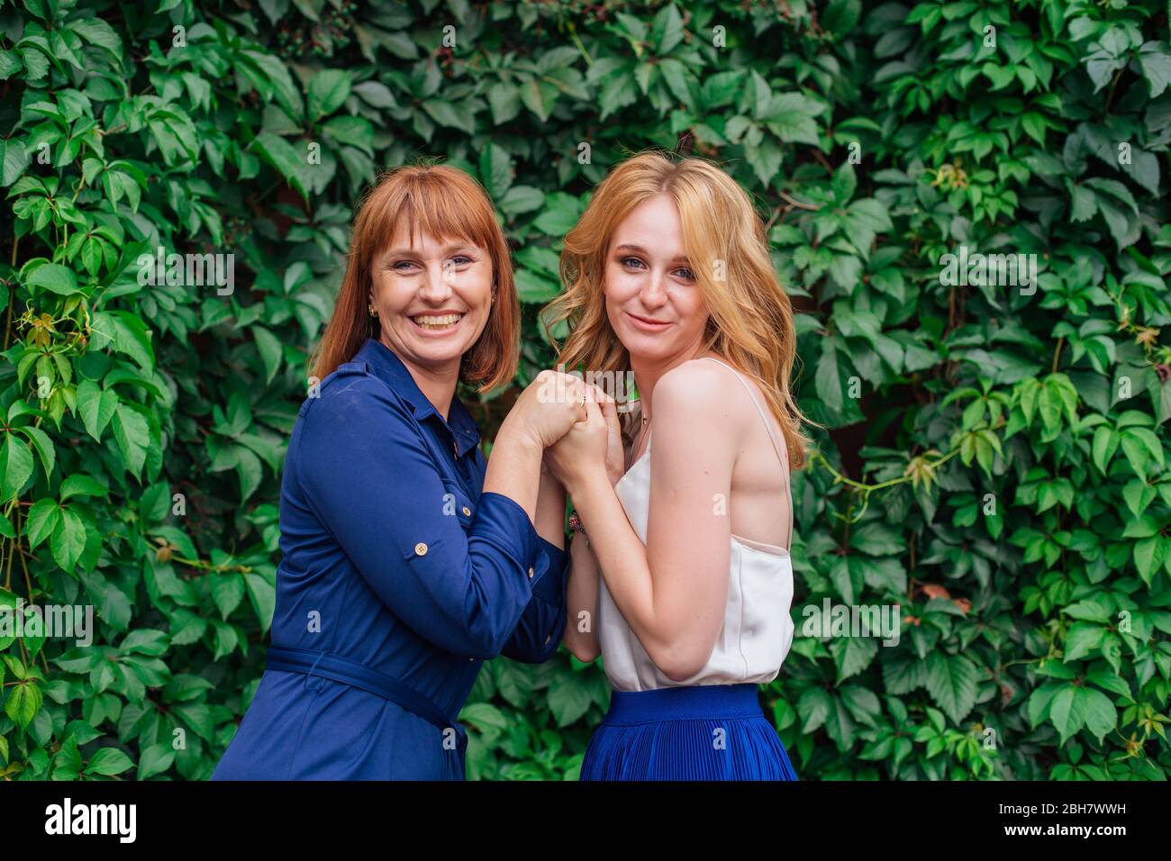 Beautiful Mother And Her Grown Up Daughter Hugging Each Other On A