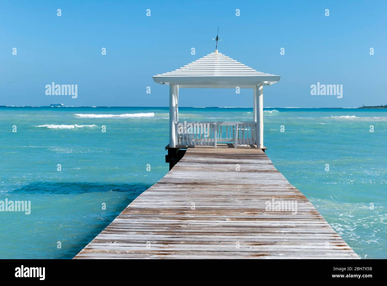 The white wooden gazebo at the end of a pier on Sandyport beach in ...
