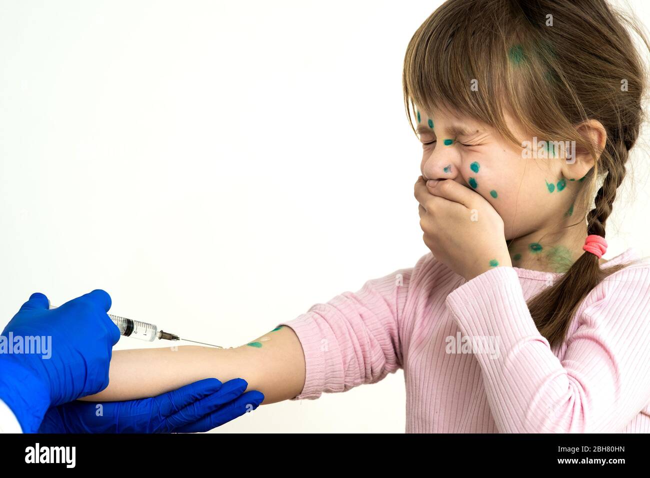 Doctor making vaccination injection to an afraid child girl sick with ...