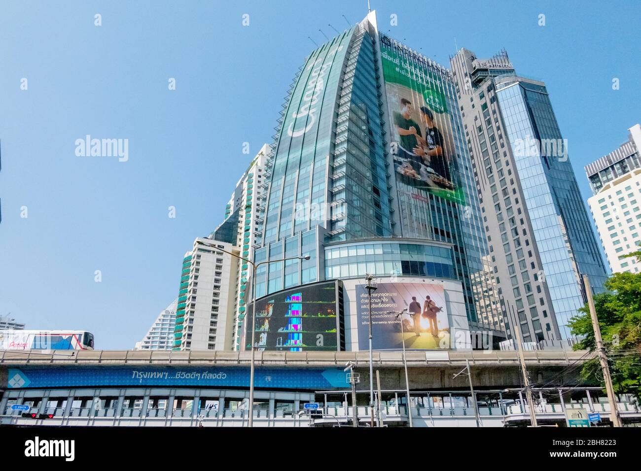 The Chang glass buildings in Bangkok city with BTS skytrain foreground ...