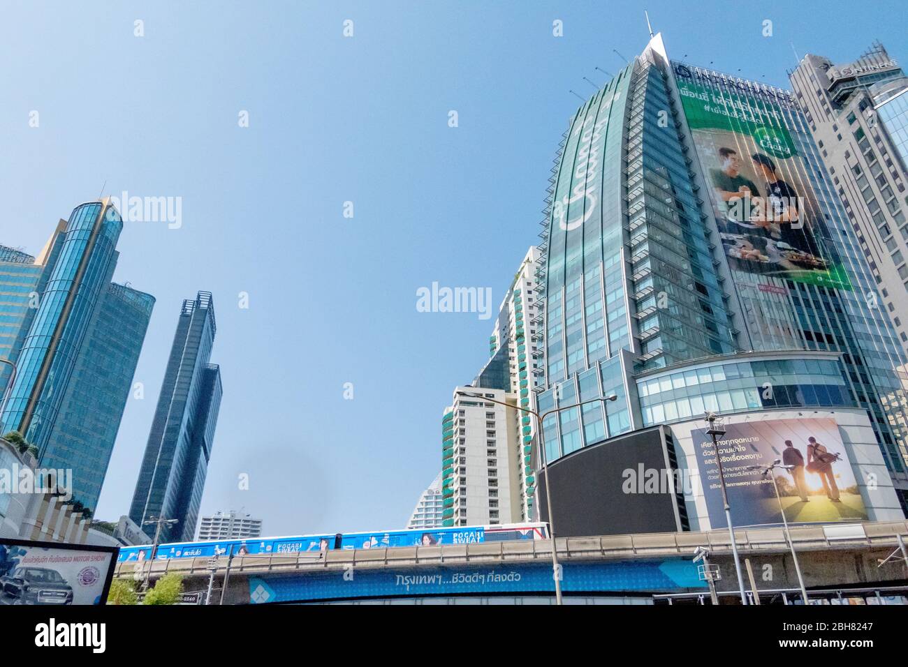 The Chang glass buildings in Bangkok city with BTS skytrain foreground ...