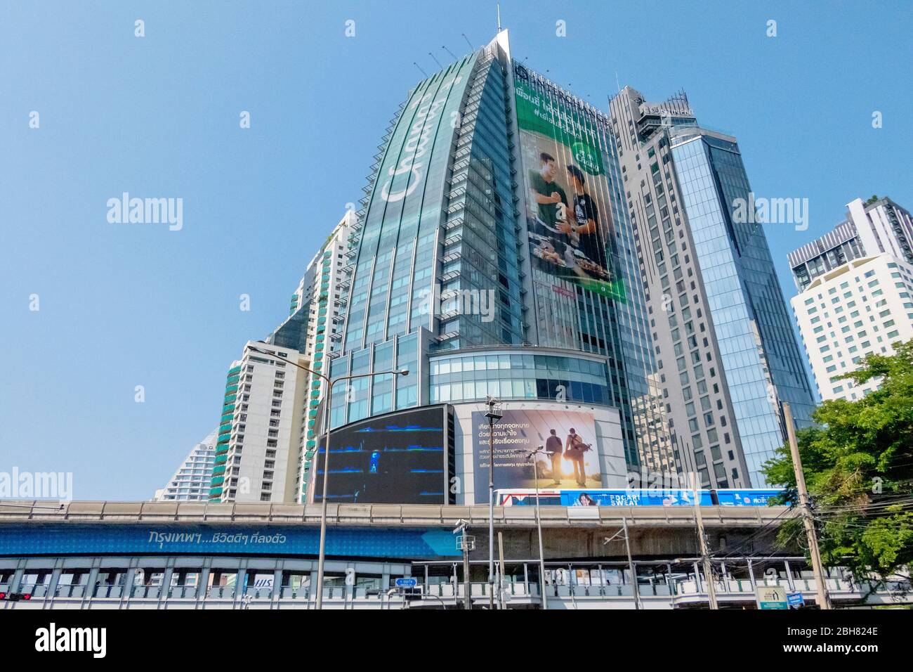 The Chang glass buildings in Bangkok city with BTS skytrain foreground ...
