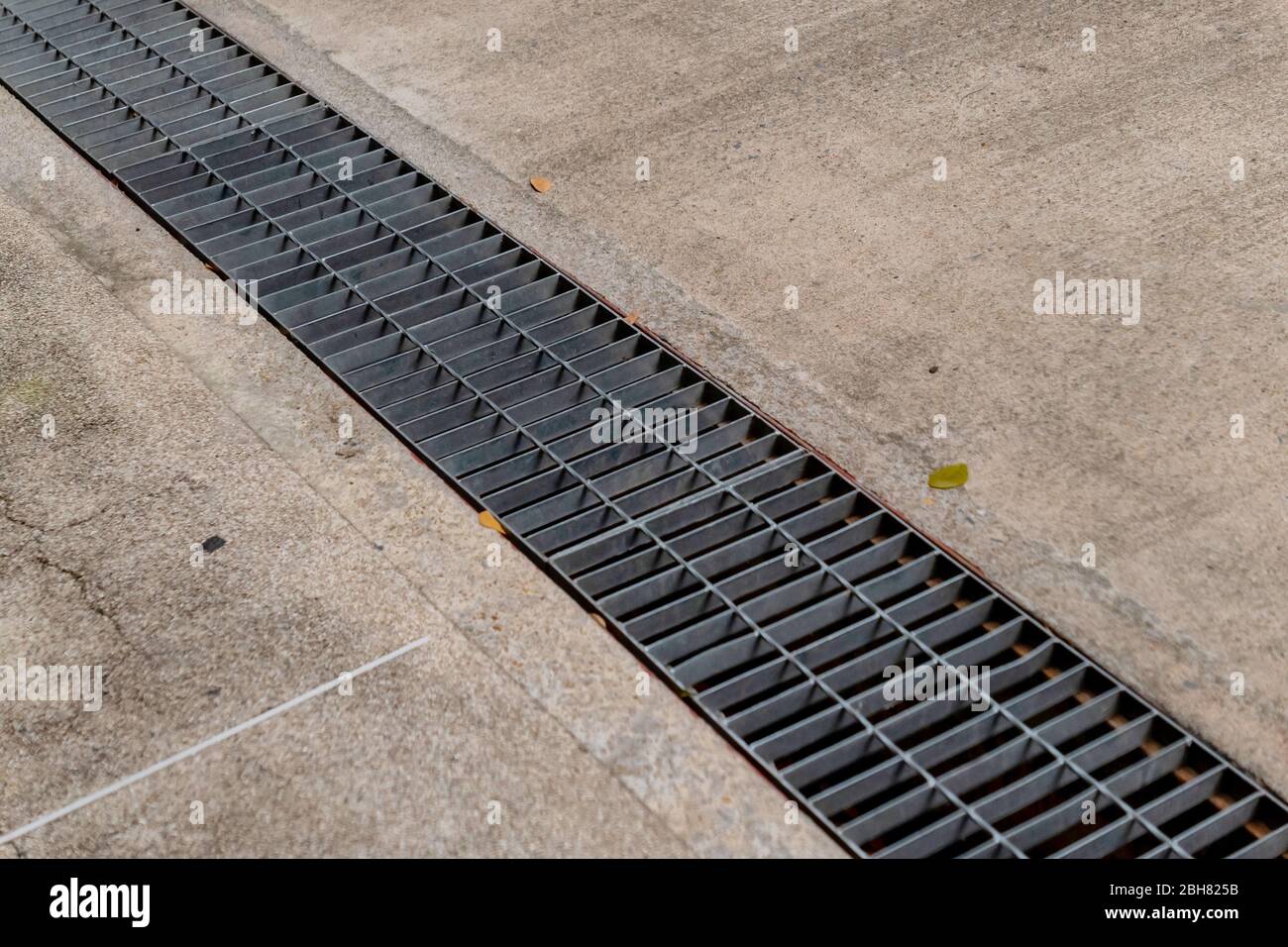 The sewage drain grate on the cement floor Stock Photo - Alamy