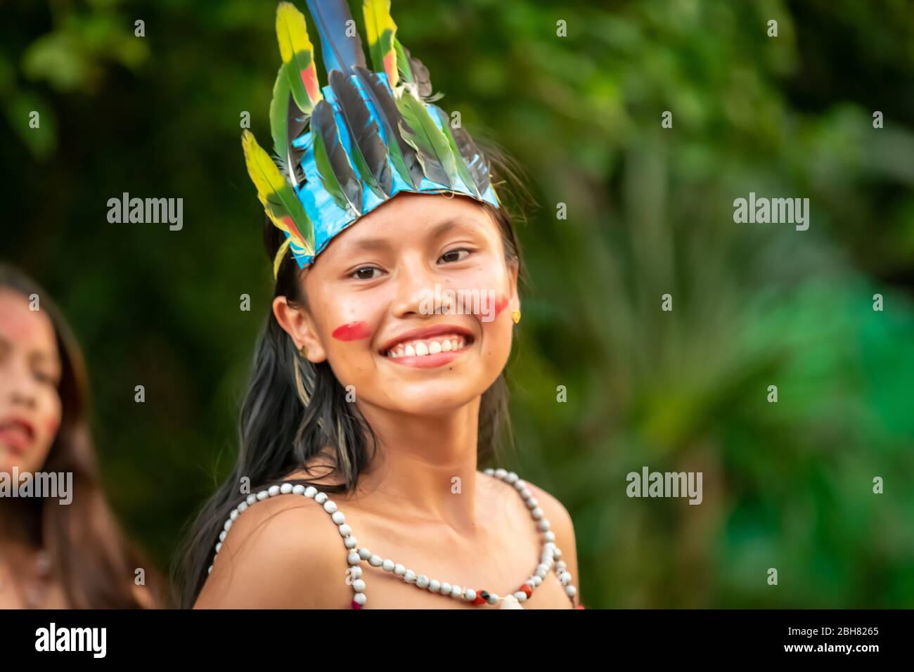 Peruvian girls dressed in traditional celebratory garb meet visitors ...