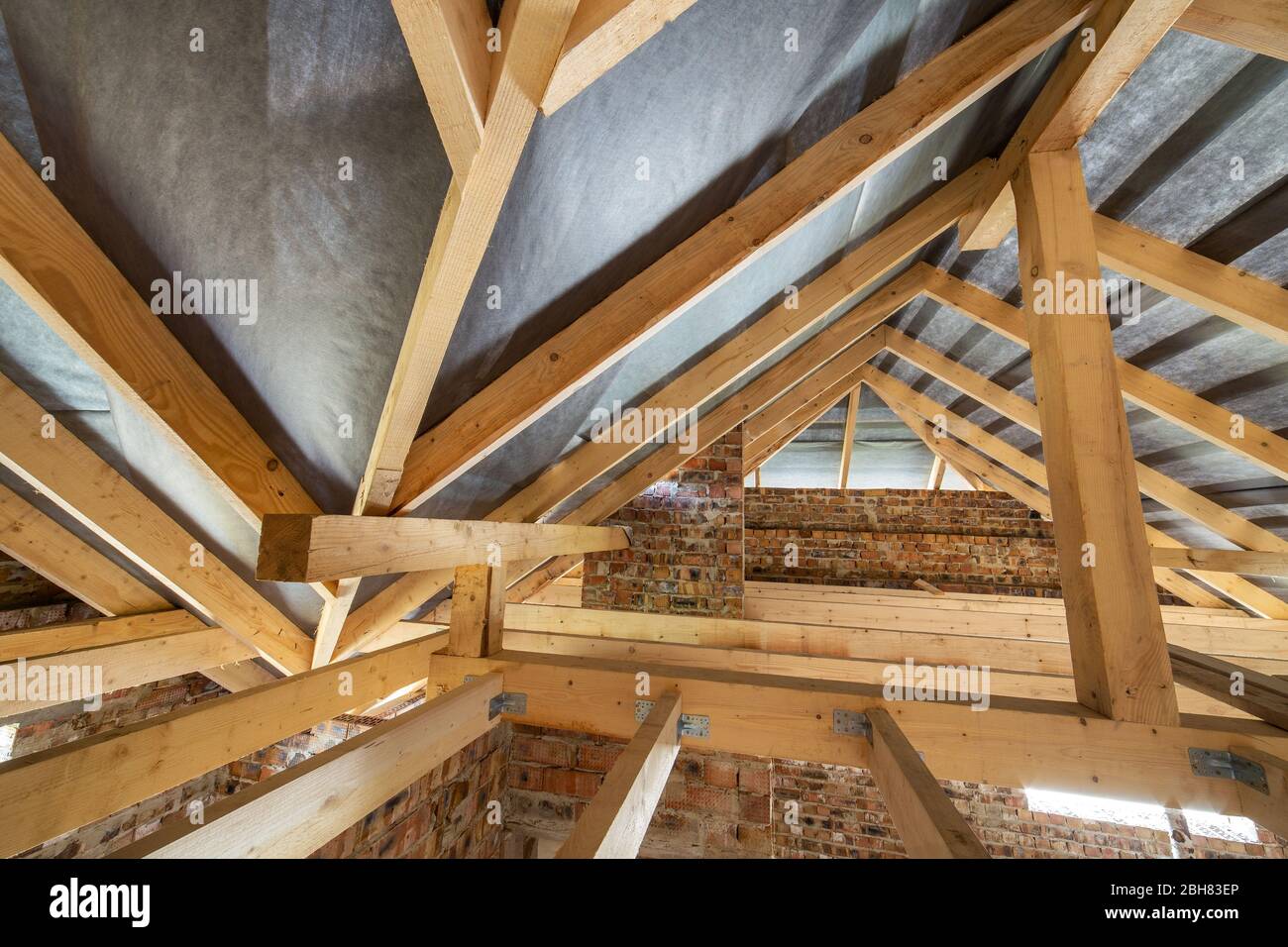 Attic of a building under construction with wooden beams of a roof ...