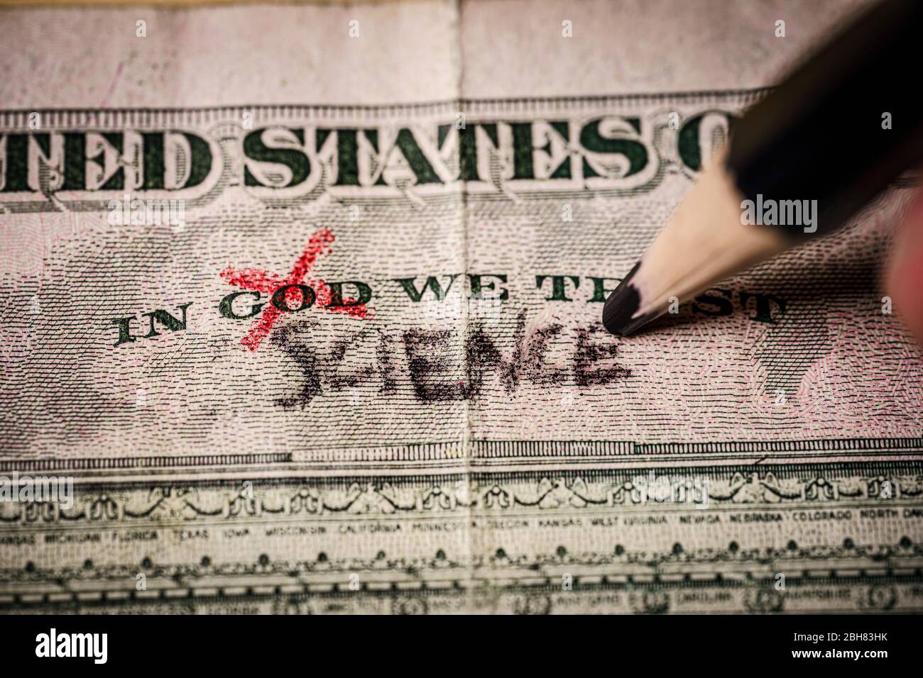 hand replacing the word god for science on on a US dollar bill Stock ...
