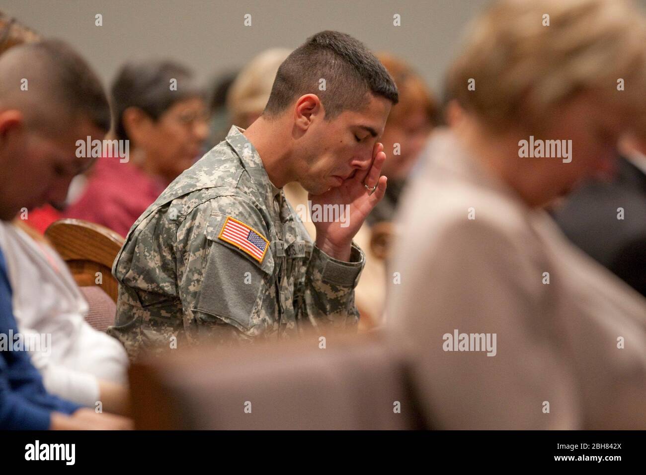 Killeen, Texas USA, November 8, 2009: PFC Cameron Parrott holds a hand ...