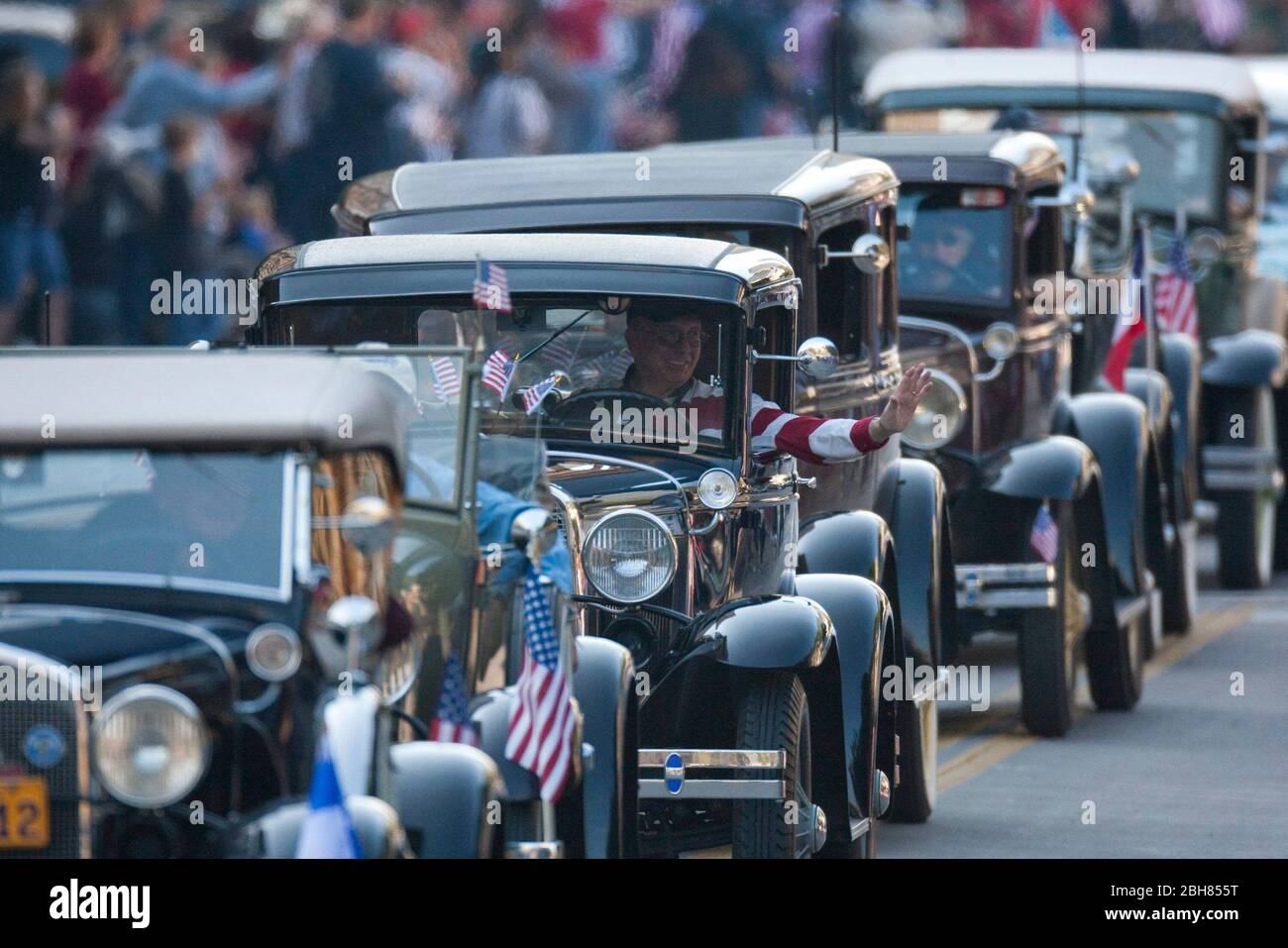 Austin Texas USA, November 11 2009: A row of antique cars drive up ...