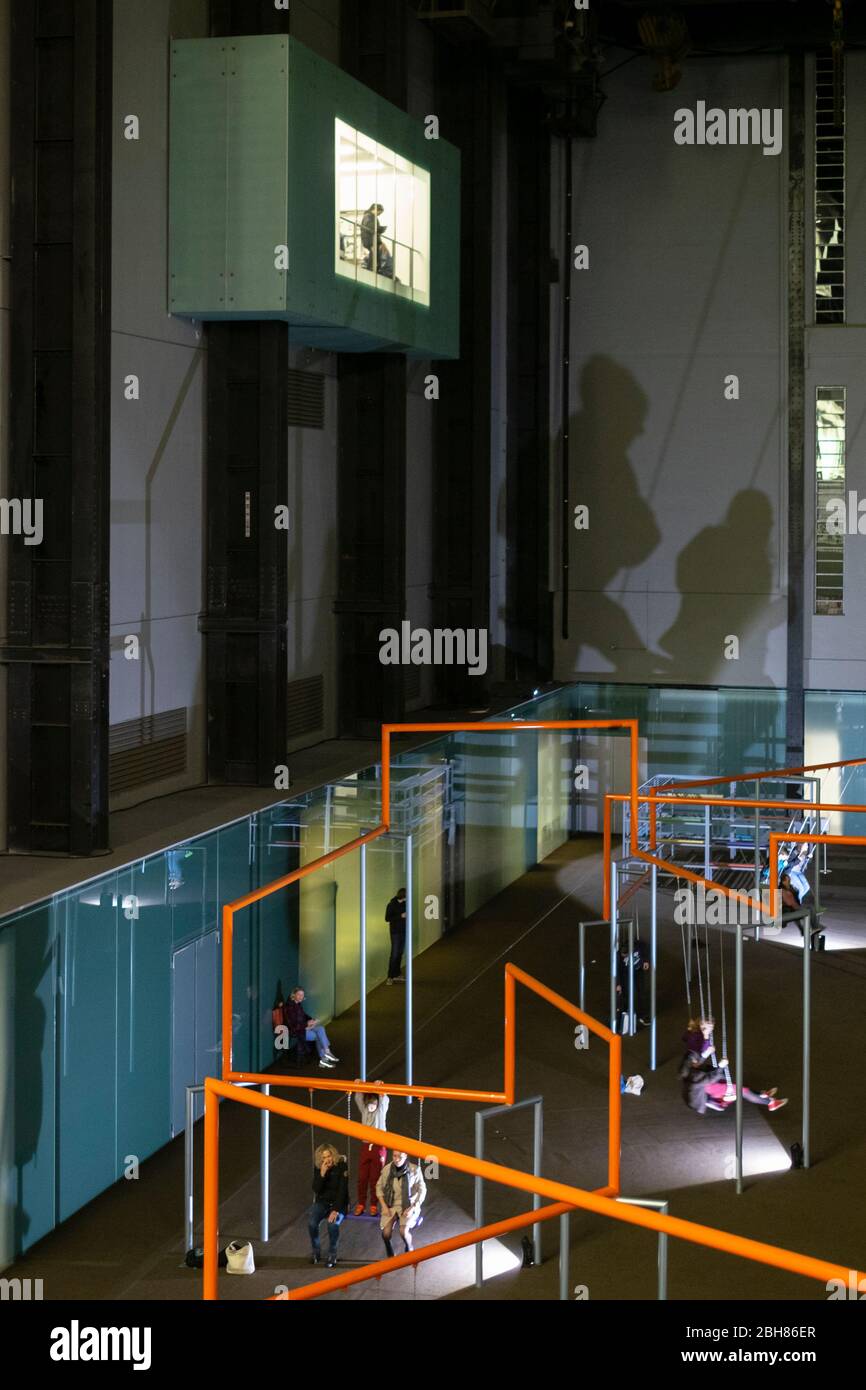 Shadows of people on swings cast on the wall at art installation by ...