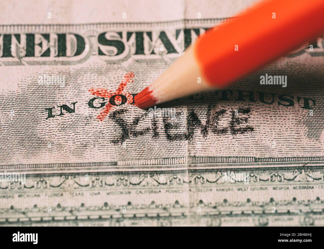 hand crossing out the word God for science on on a US dollar bill Stock ...