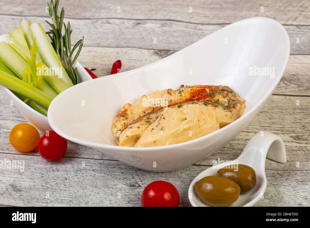 Vegan cuisine - Humus with celery sticks Stock Photo - Alamy