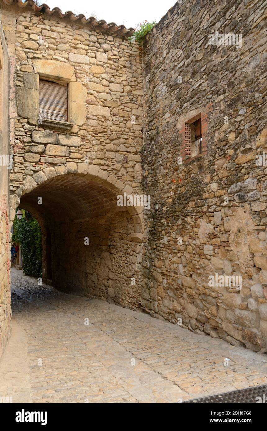 Stone passageway in the medieval village of Peratallada, located in the ...